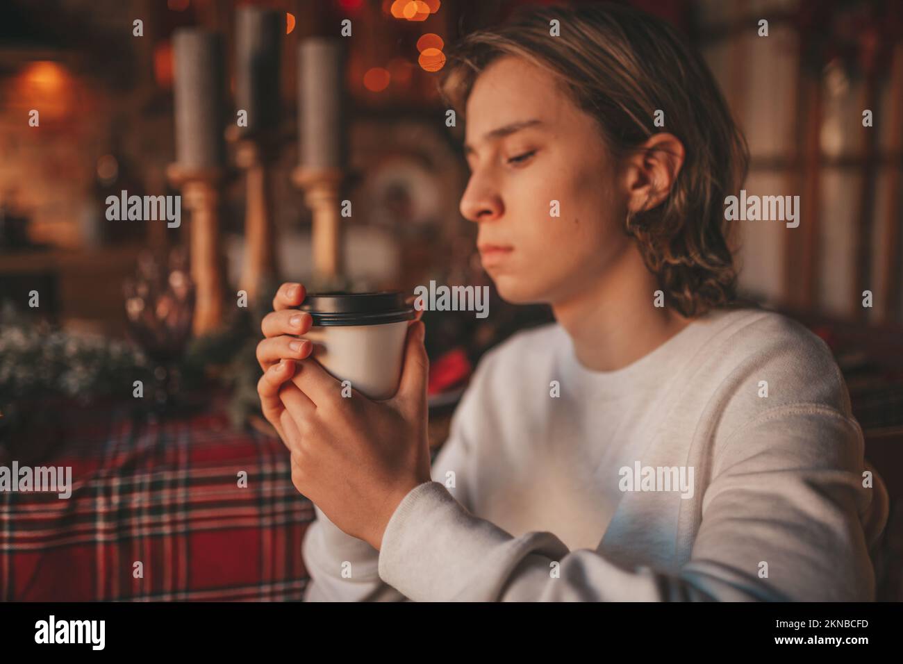 Young teen boy with long hair thoughtful look sad eyes negative mood ...