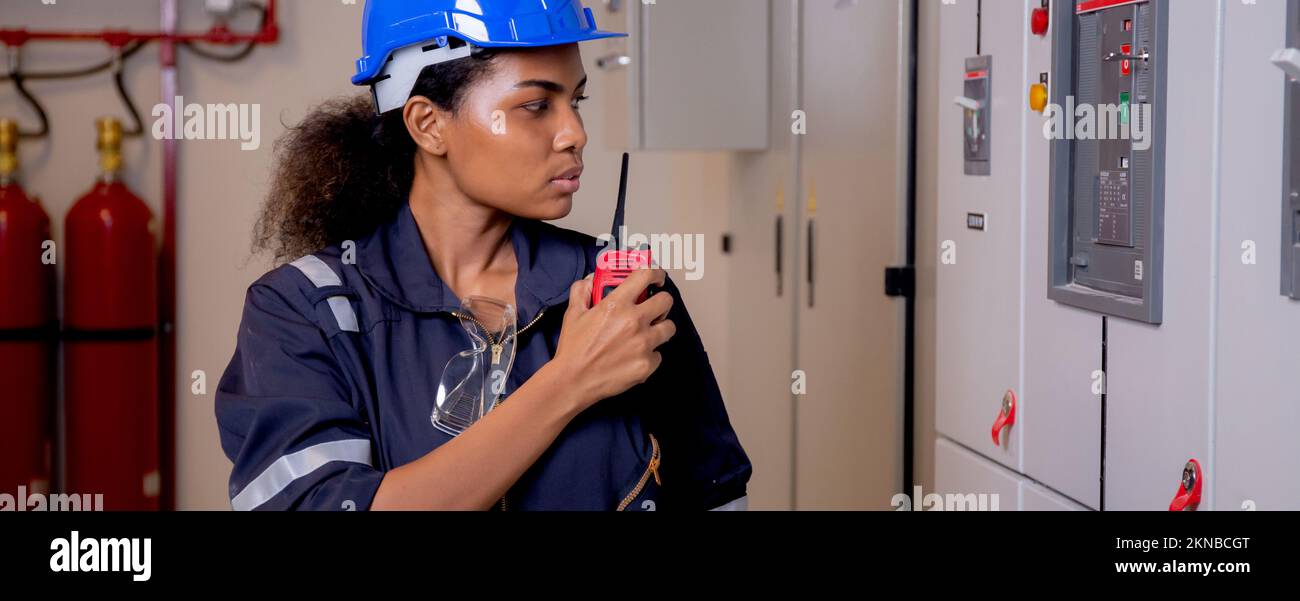 Electrical young asian woman engineer examining maintenance cabinet ...