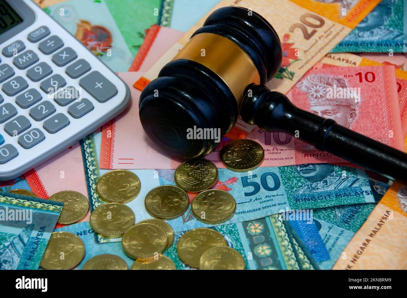 Side view of various Malaysia Ringgit currency and coins with gavel and ...