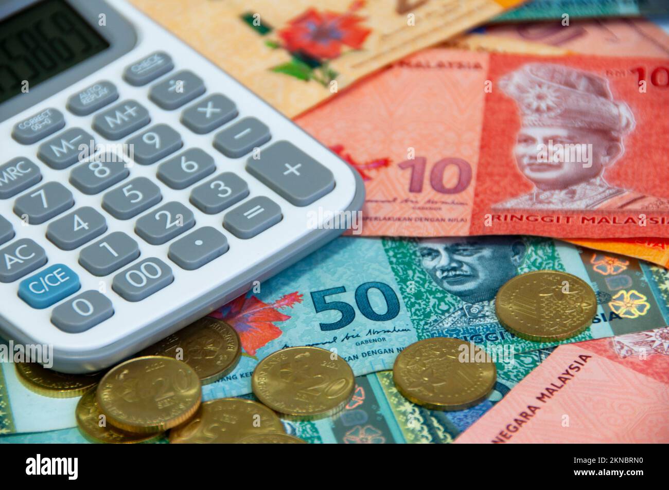 Close up of various Malaysia Ringgit currency and coins with calculator ...