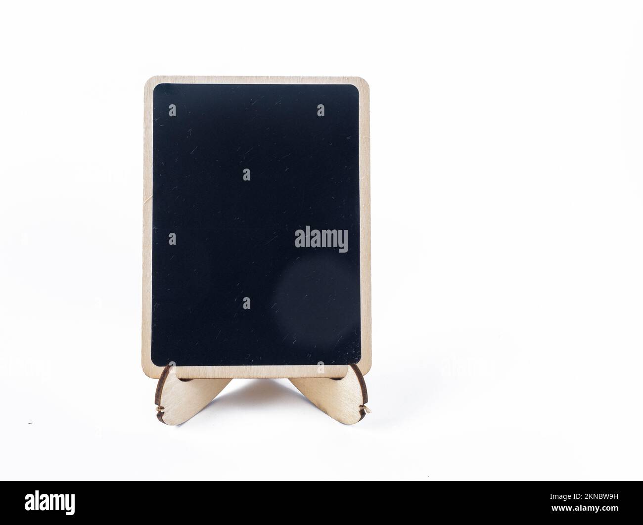 small chalk blackboard in wooden easel stand isolated on a white ...