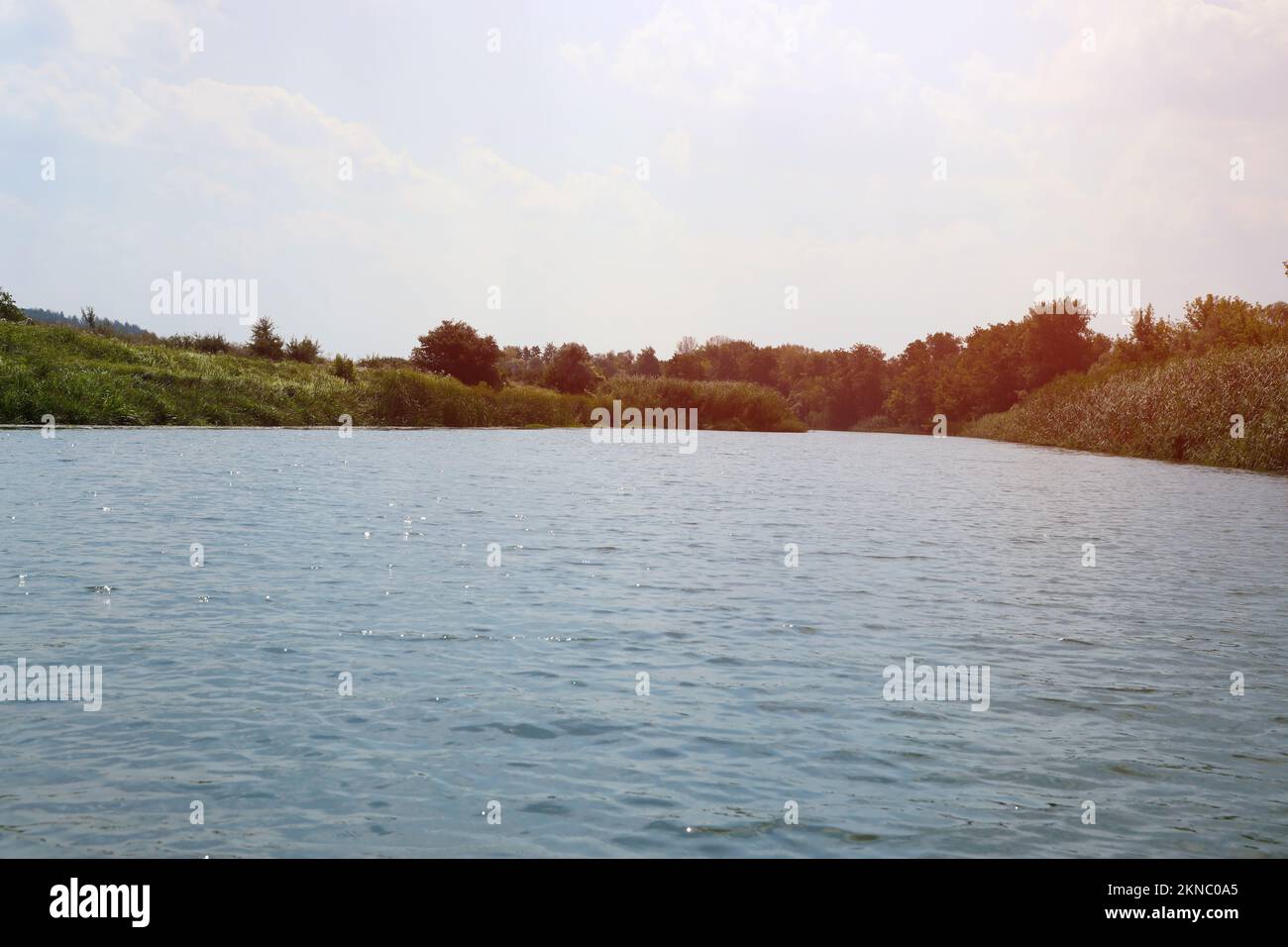 Sunny spring morning on meadow near river. Scenic rural landscape ...