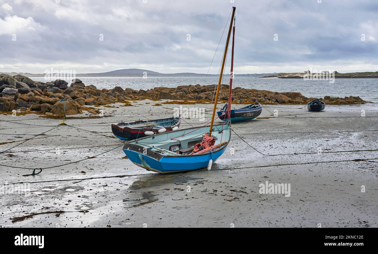 Traditional sailing boats at low tide in a sandy bay at the irish west ...