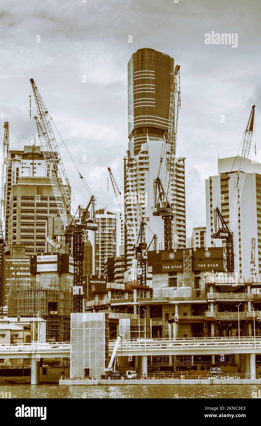 Busy facade in constructing cities with cranes building below and above ...