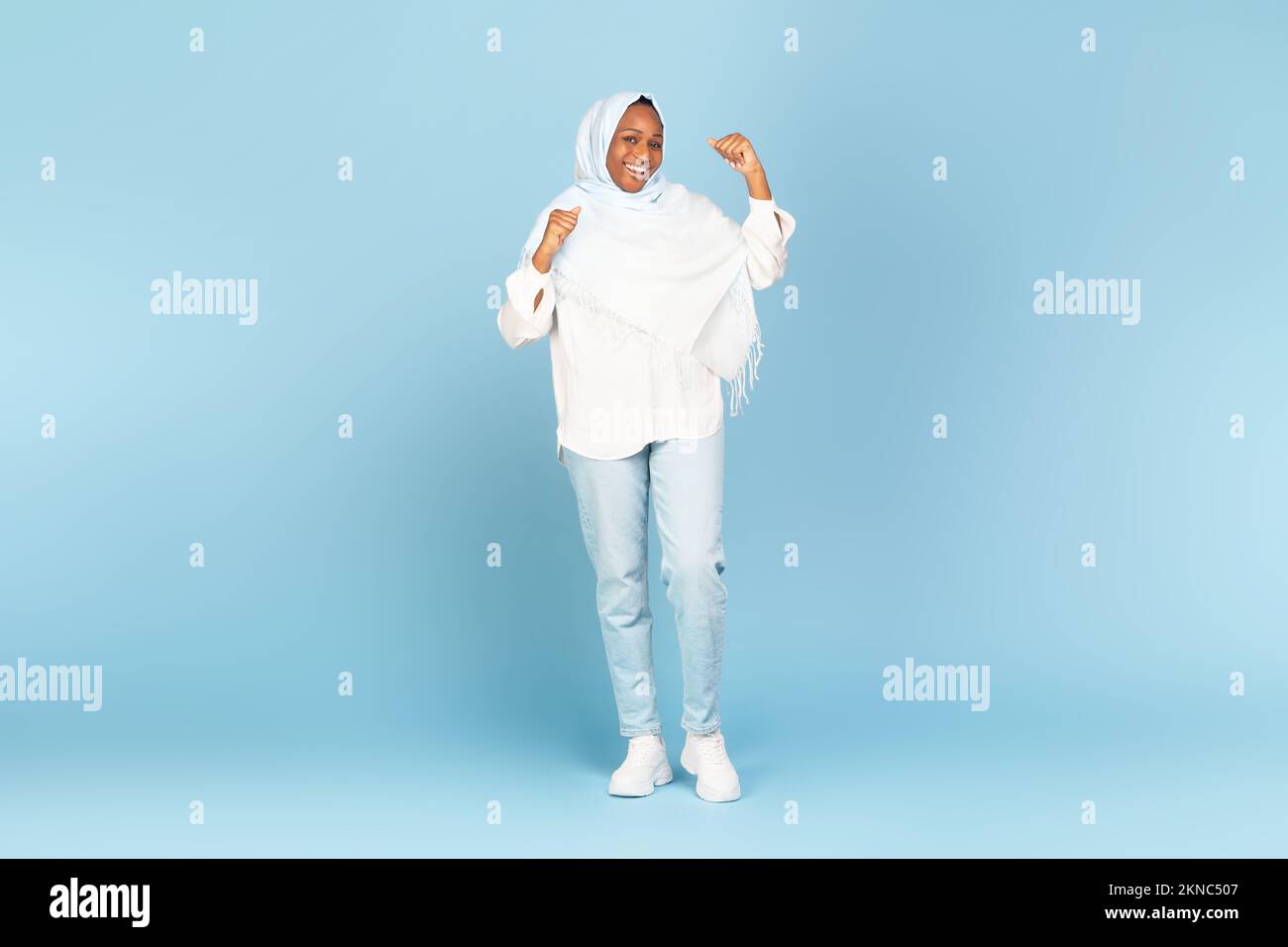 Happy black woman in hijab celebrating success, lady cheering luck with ...