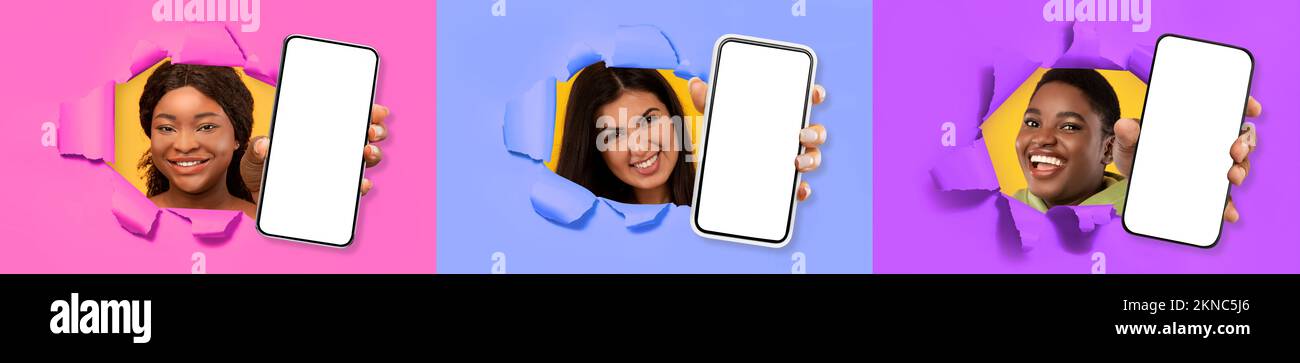 Three excited young multicultural women holding three big cell phones ...
