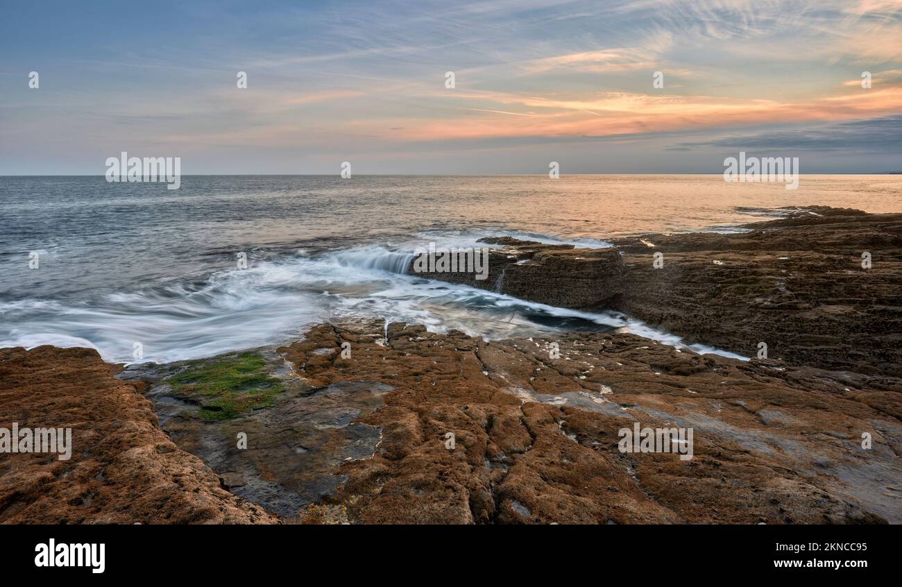 rocky coastline at sunset in southern Republic of Ireland near ...