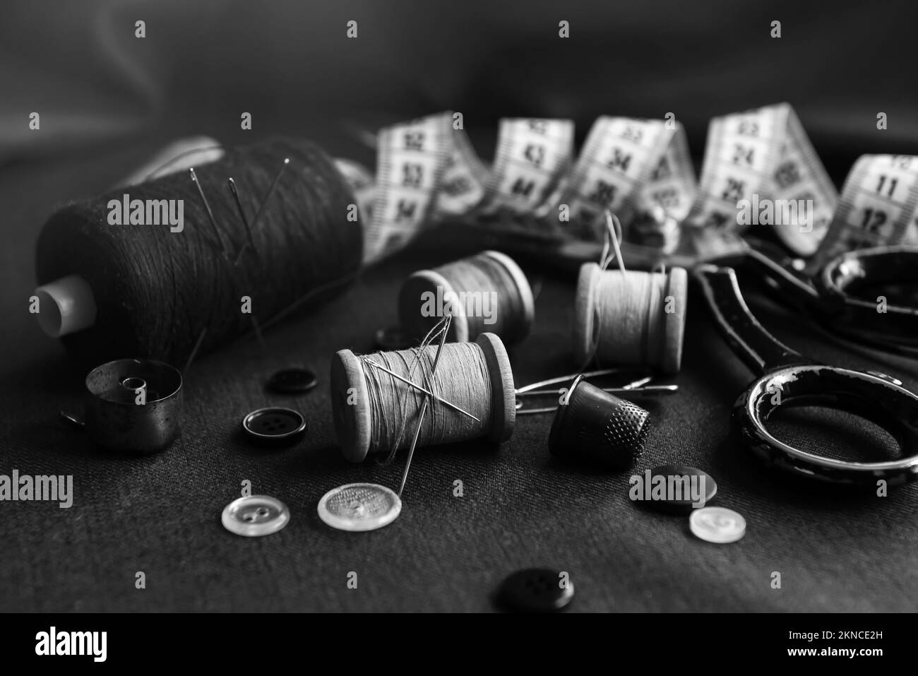 Retro tools for cutting and sewing. Needle with thread, thimble, sewing ...