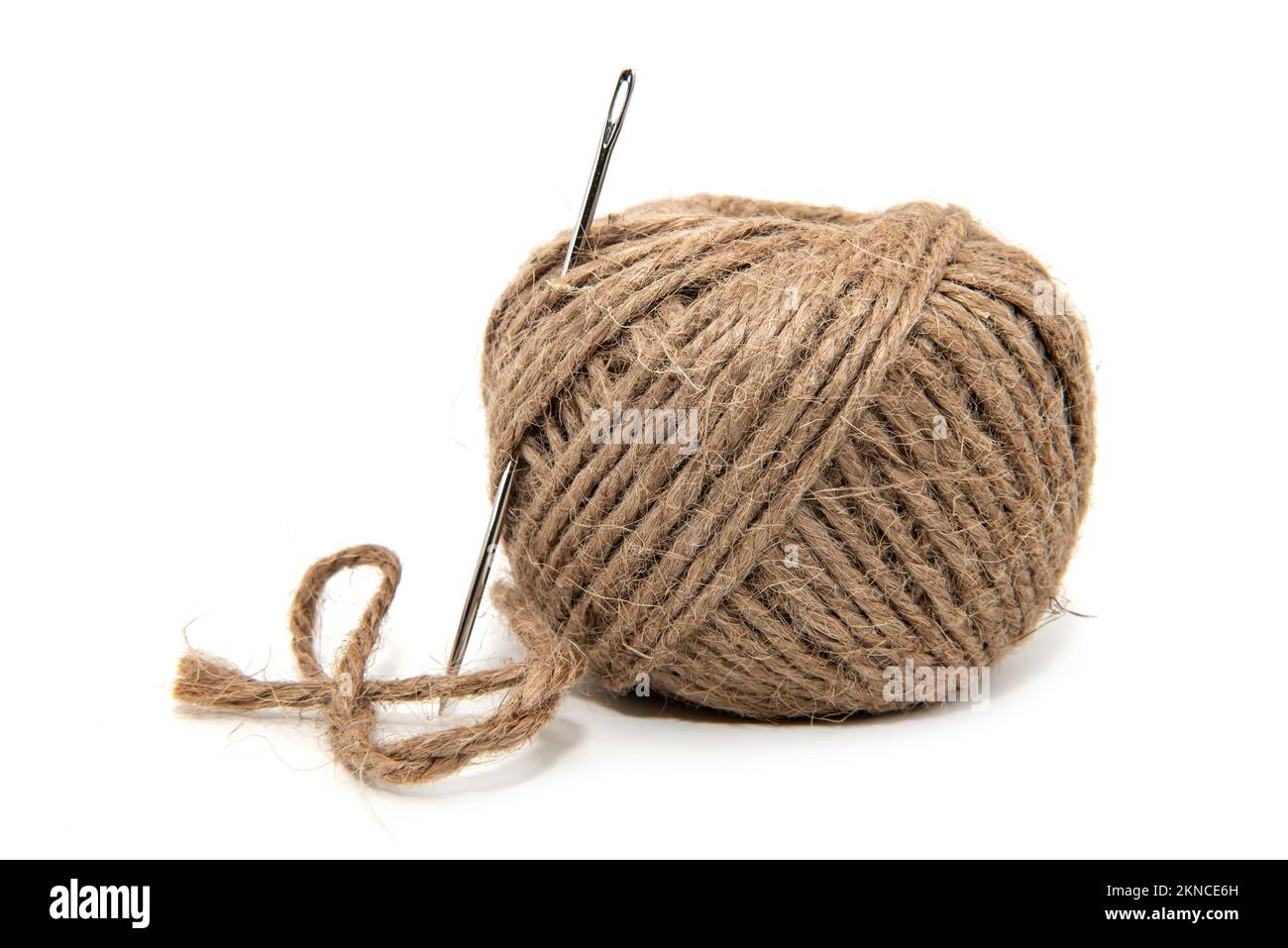 A ball of twine with a needle on a white background. Rope isolate Stock ...