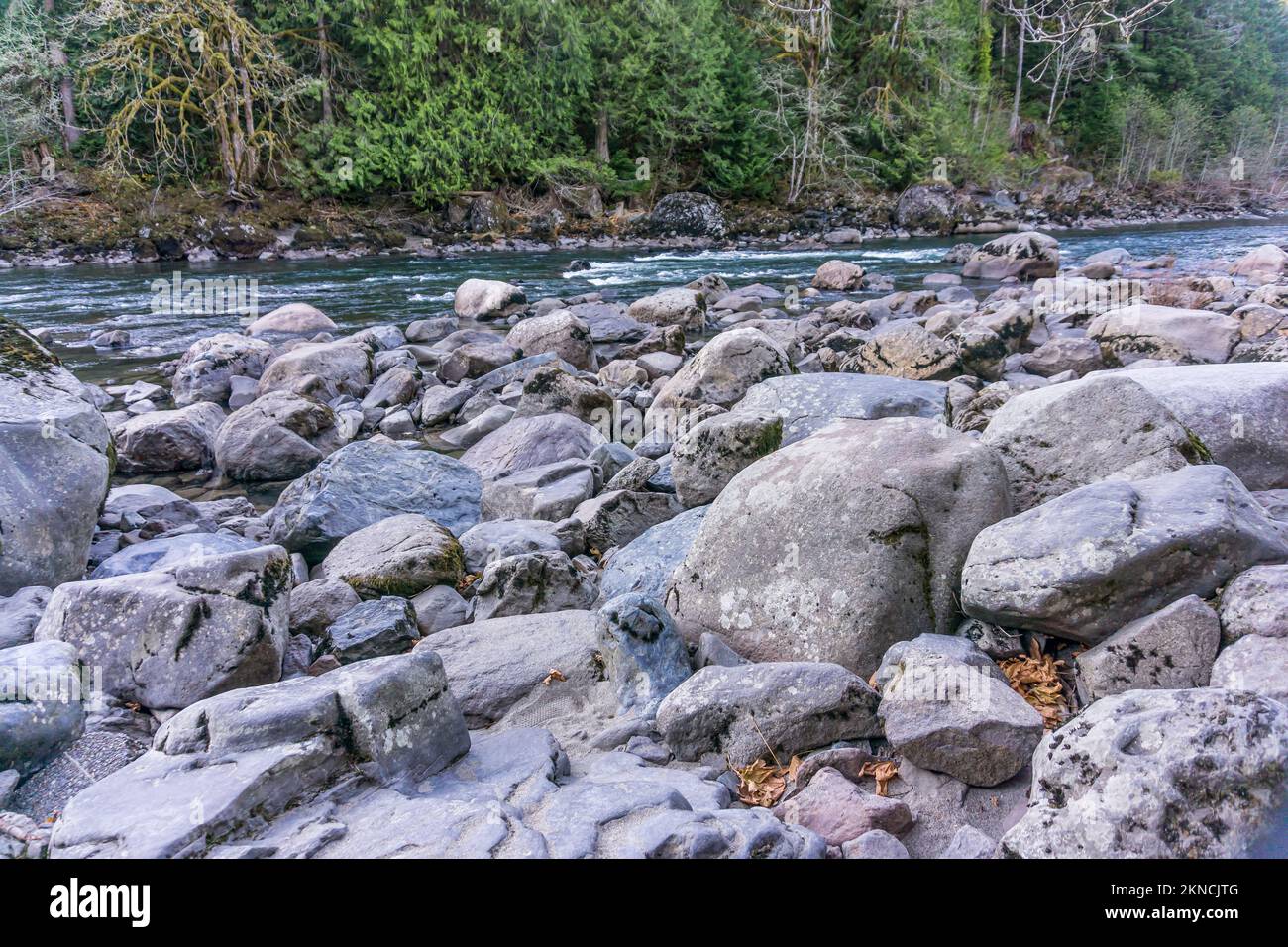 Large rocks line the Snoqaulmie River in Washington State Stock Photo ...