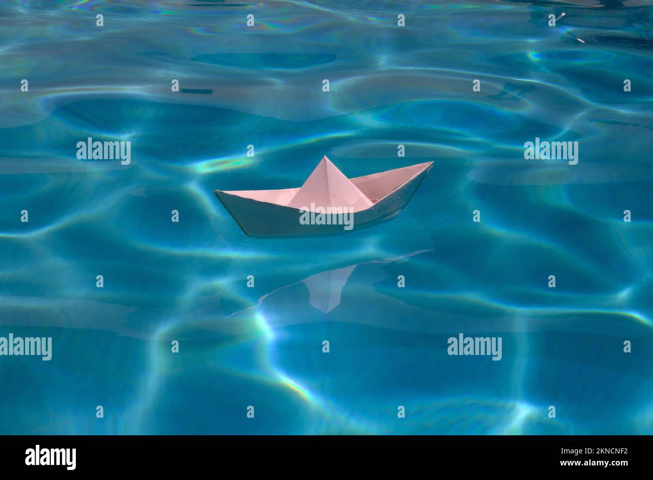 Paper boat sailing on blue water surface. Paper boat on the sea ...