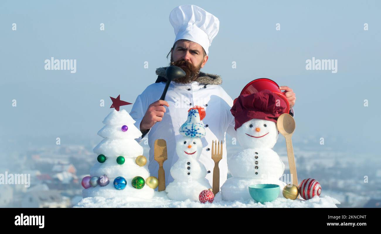 Winter cooking. Snow man cook chef on the snow outdoor background ...