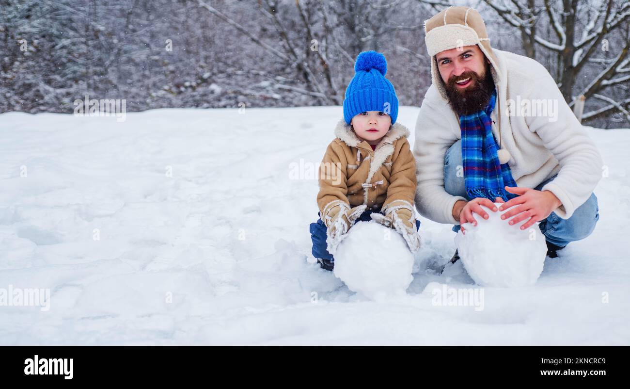 Cute little child boy and happy father on snowy field outdoor. Father ...