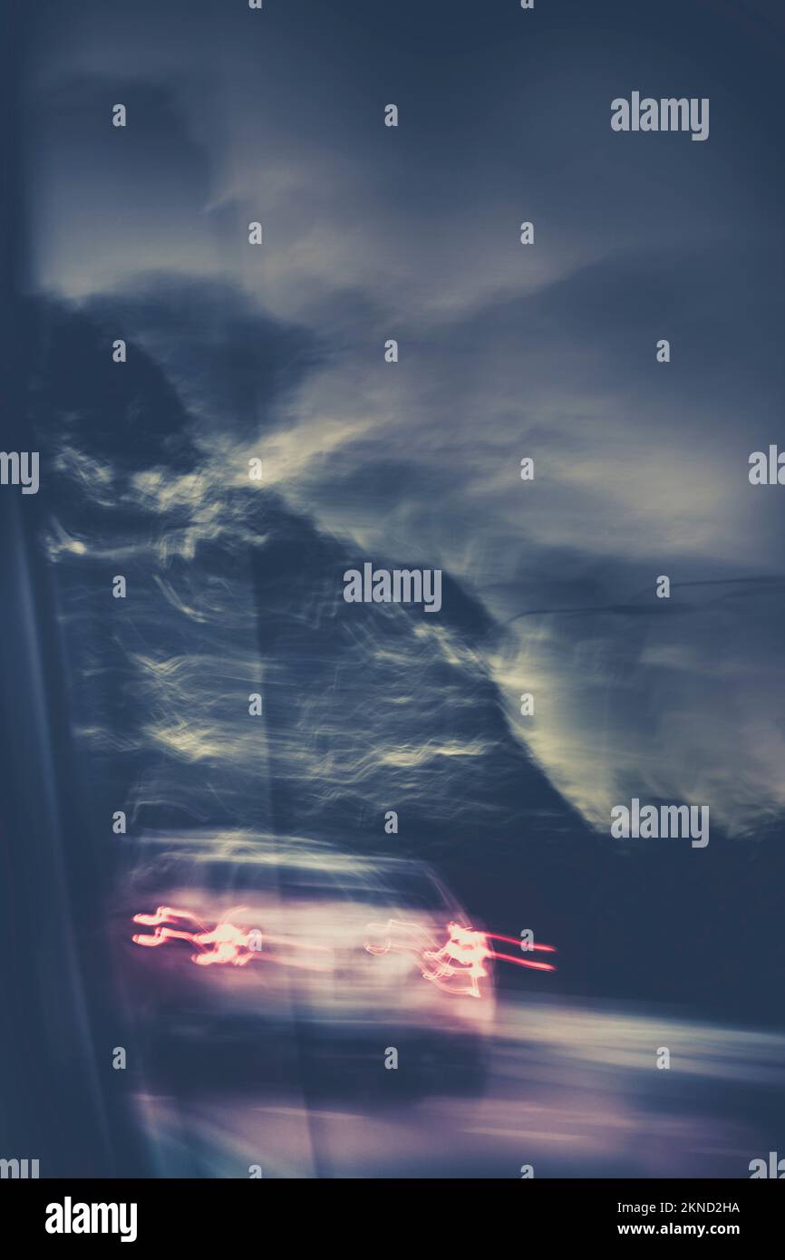 Unique defocussed window view of a modern car speeding away at fast ...