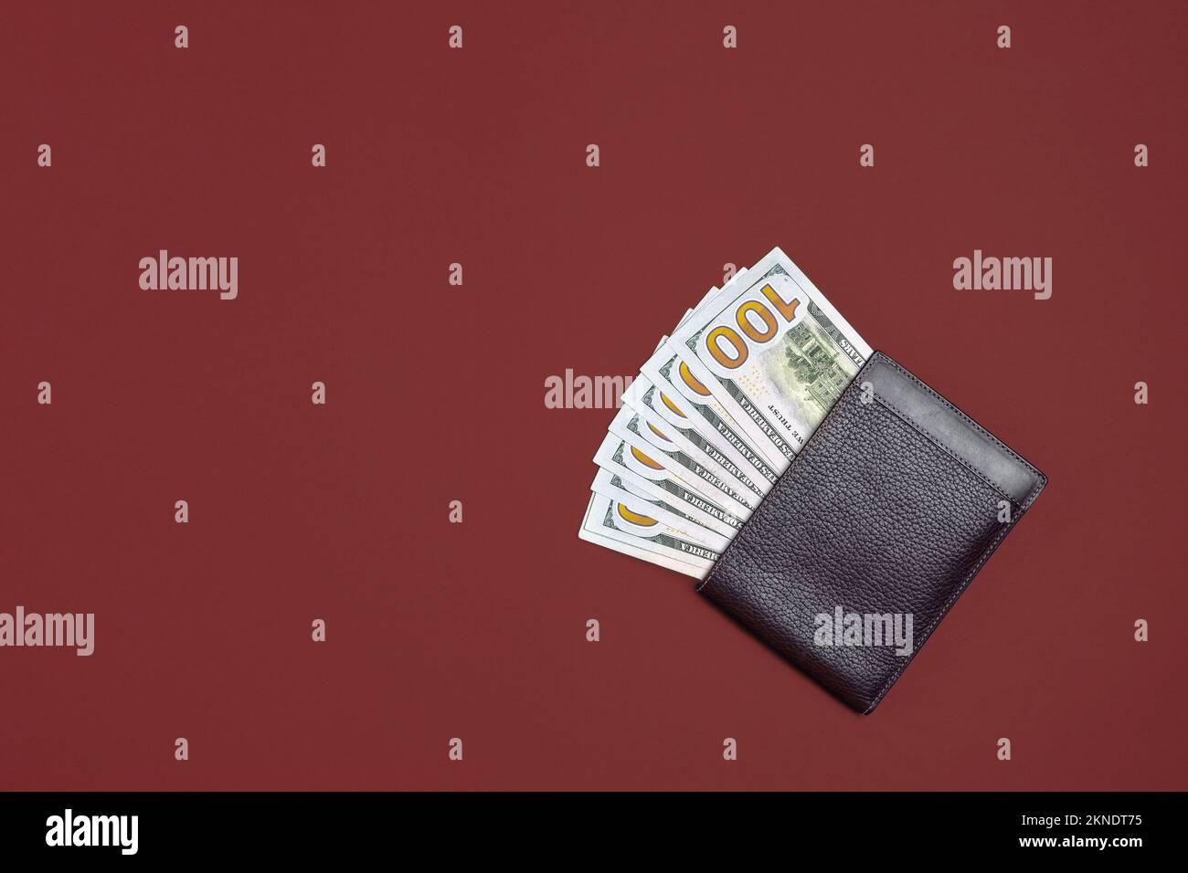 Hundred-dollar bills are visible from brown leather wallet. American ...