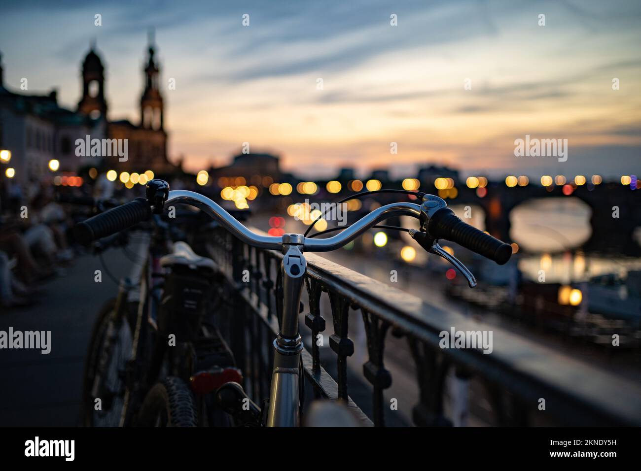 Handlebars of a bike standing in Dresden (Germany) city centre at dusk ...