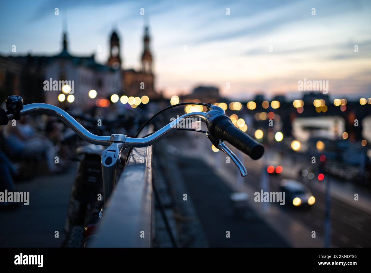 Handlebars of a bike standing in Dresden (Germany) city centre at dusk ...