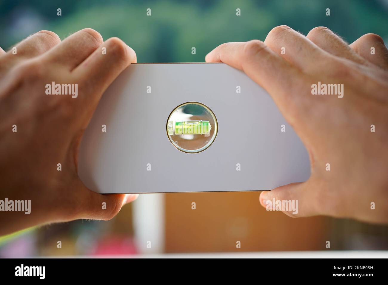 Hands carefully balancing a bubble level Stock Photo - Alamy
