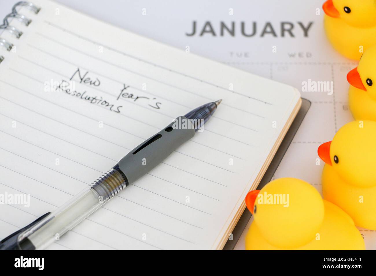 Four yellow rubber ducks on top of January Calendar overlooking notepad ...