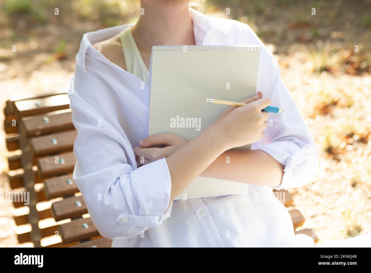 Anonymous girl making notes or drawing in the blank paper book Stock ...