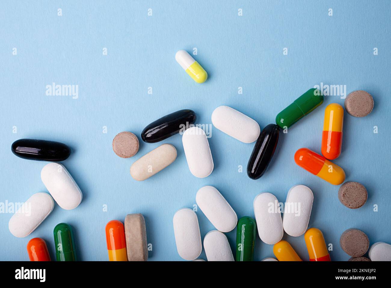 Top view of different pills on blue background,copy space for text ...