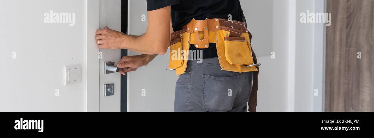Male worker handyman carpenter installation into wood door Stock Photo ...