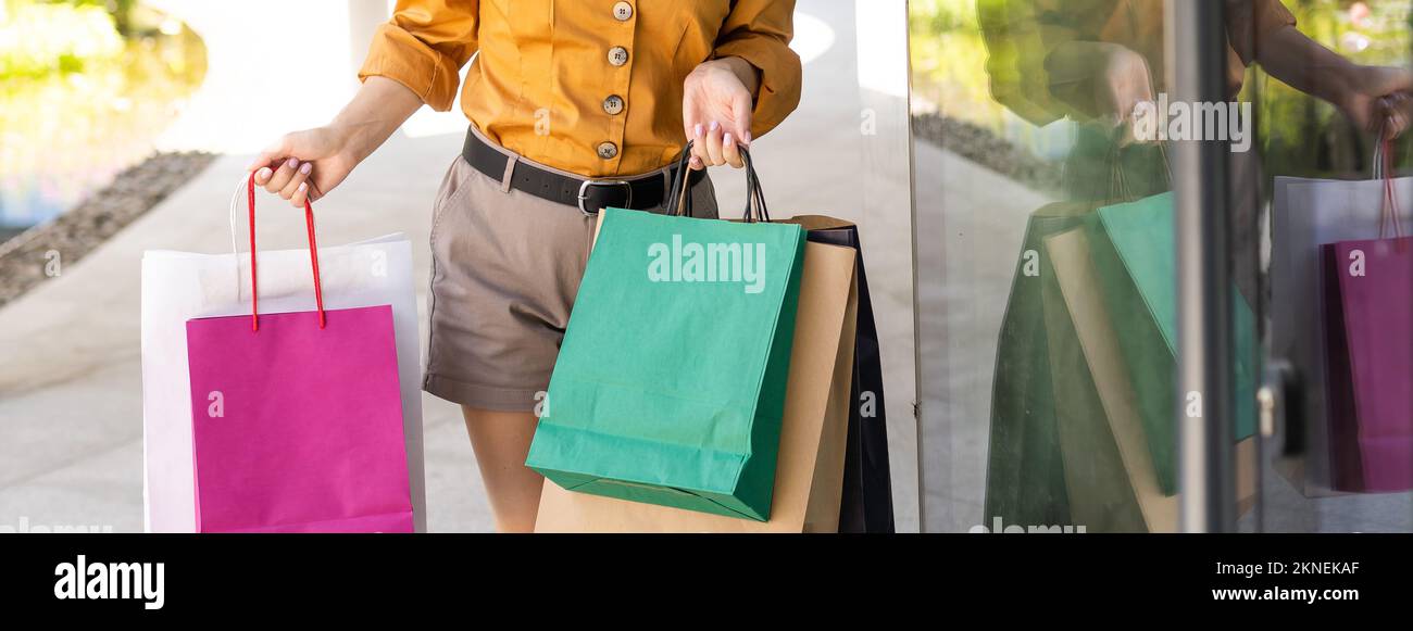 Young woman with face mask shopping during virus pandemic Stock Photo ...