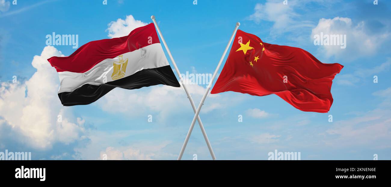 two crossed flags china and Egypt waving in wind at cloudy sky. Concept ...