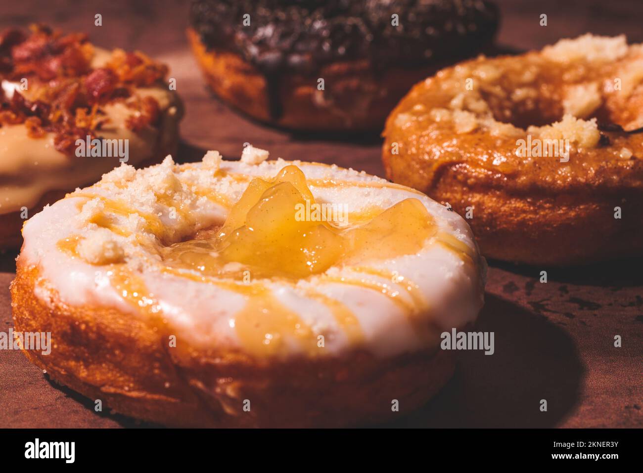 A close up of a fall-themed donut with white glaze and custard filling ...