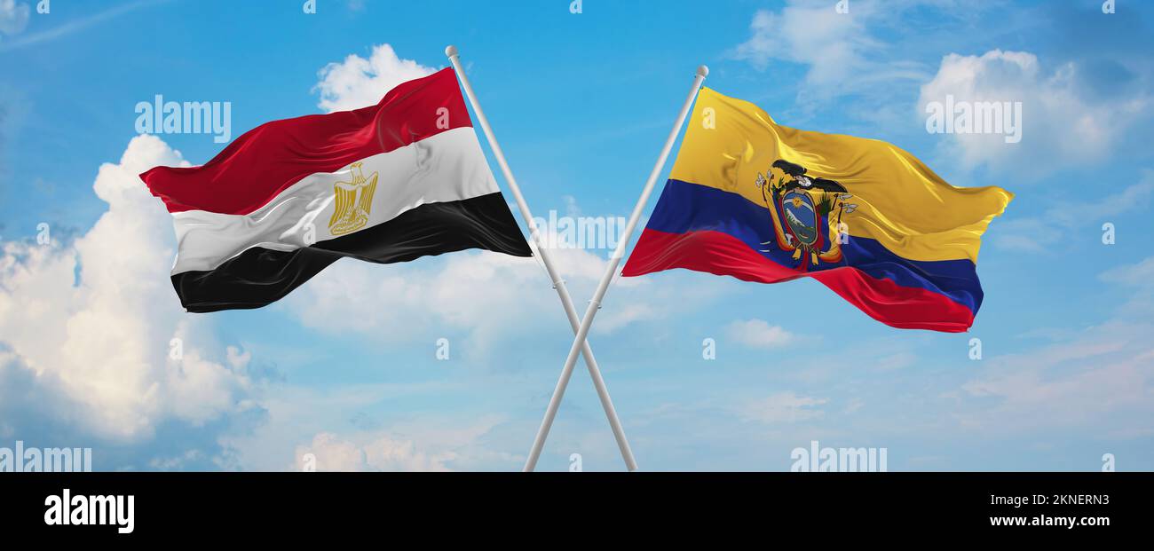 two crossed flags Ecuador and Egypt waving in wind at cloudy sky ...
