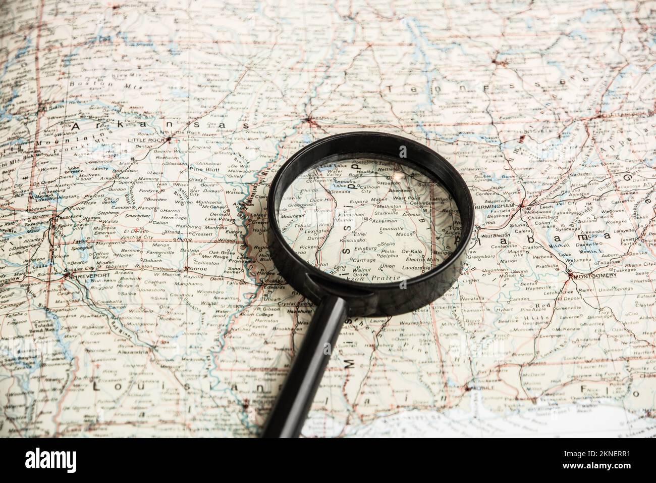 world atlas under magnifying glass Stock Photo - Alamy