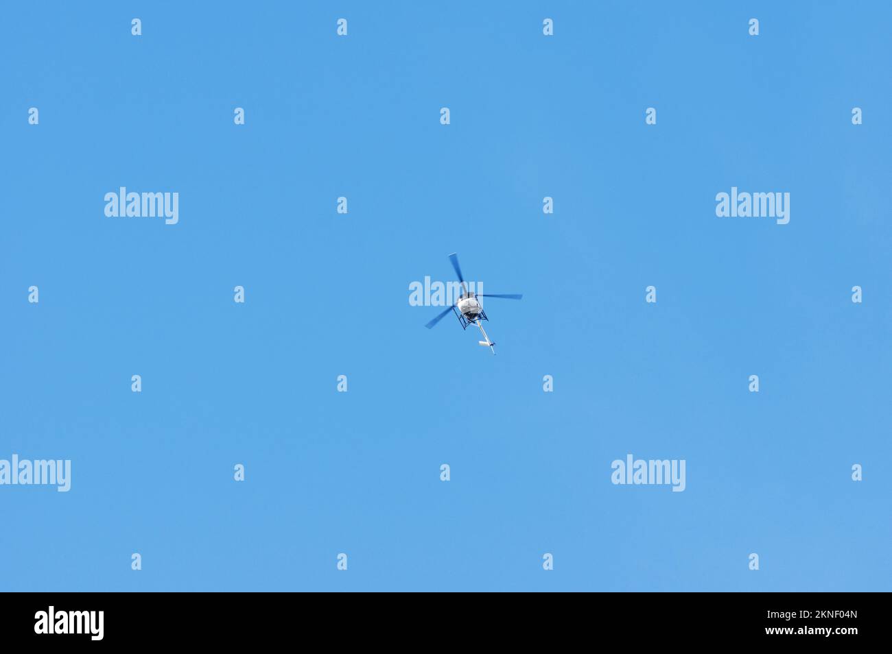 Helicopter flying high in the sky, Netherlands. With a clear blue ...