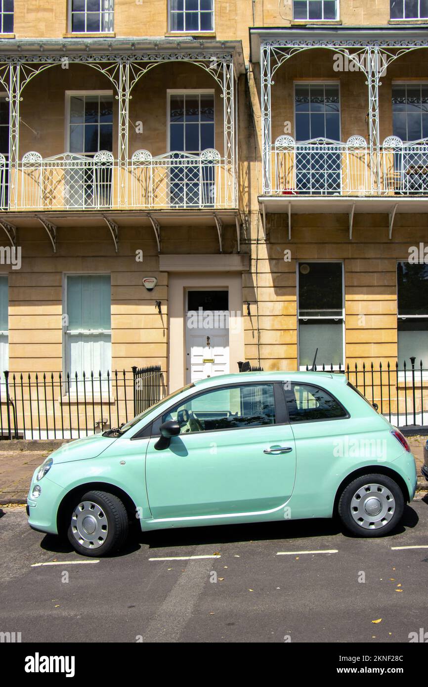 mint green fiat 500 in front of row of victorian houses with cast iron ...