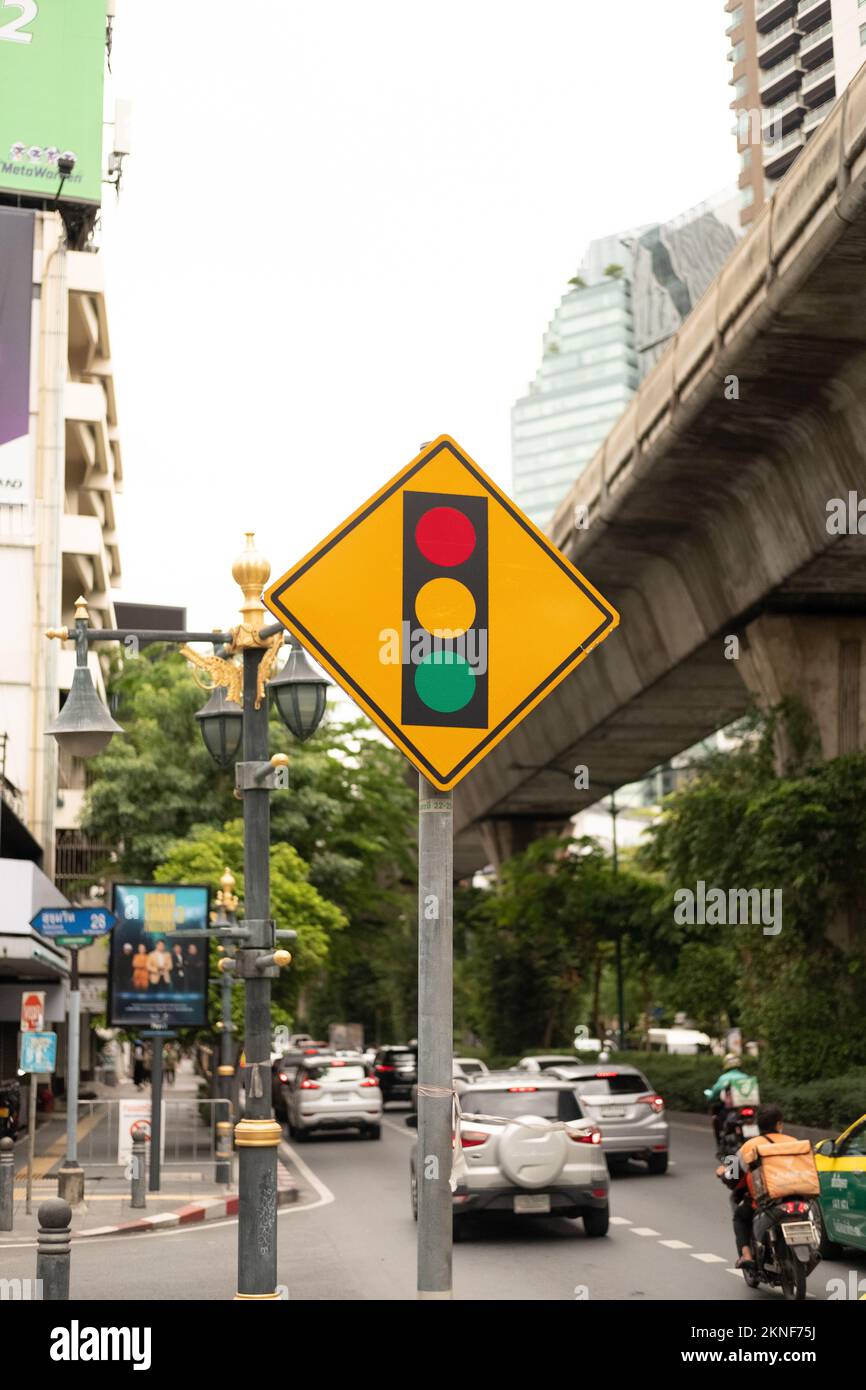 A Road sign signaling red light ahead in the street with cars Stock ...