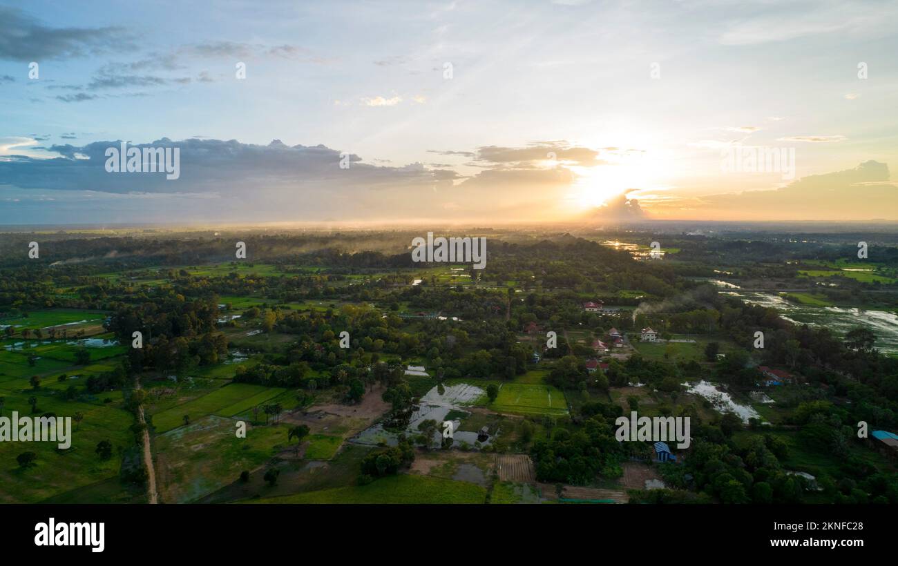 A drone shot of a rural residential area with green vegetation and the ...