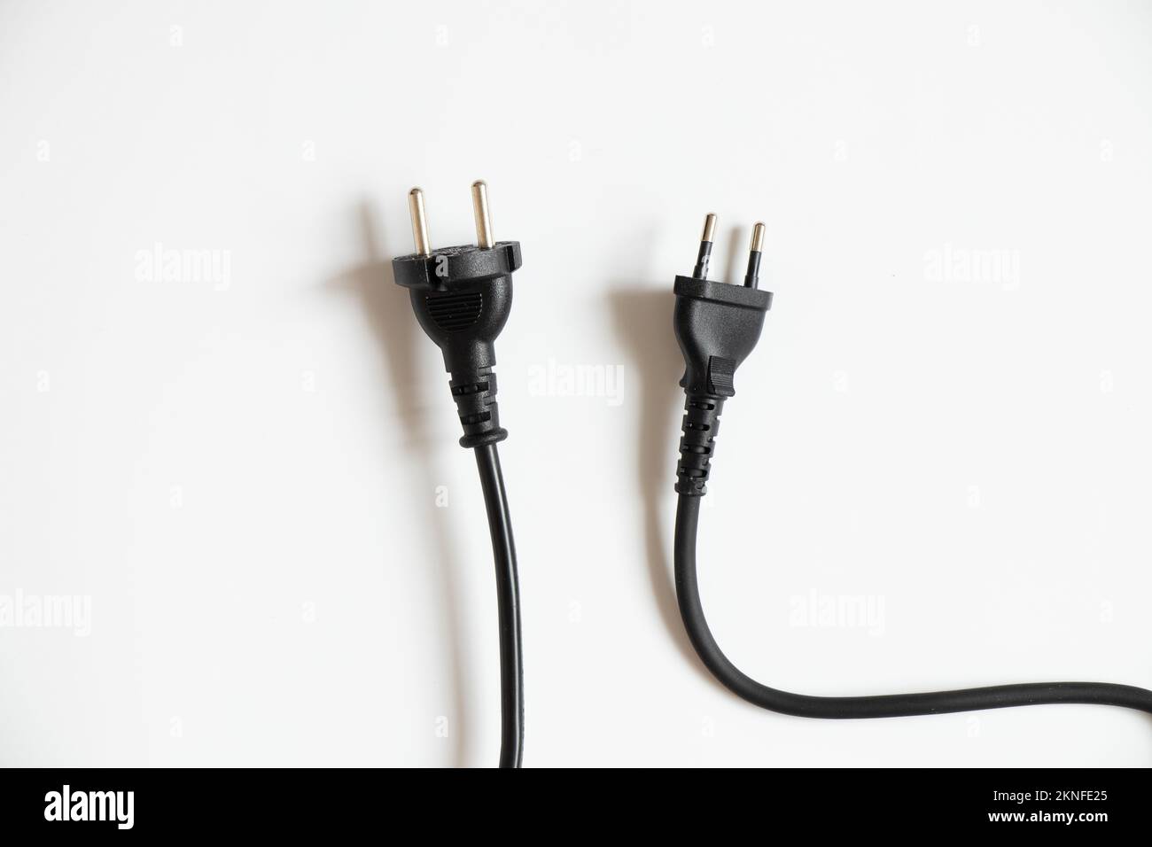 Two black cables with plugs on a white background, cable and current ...