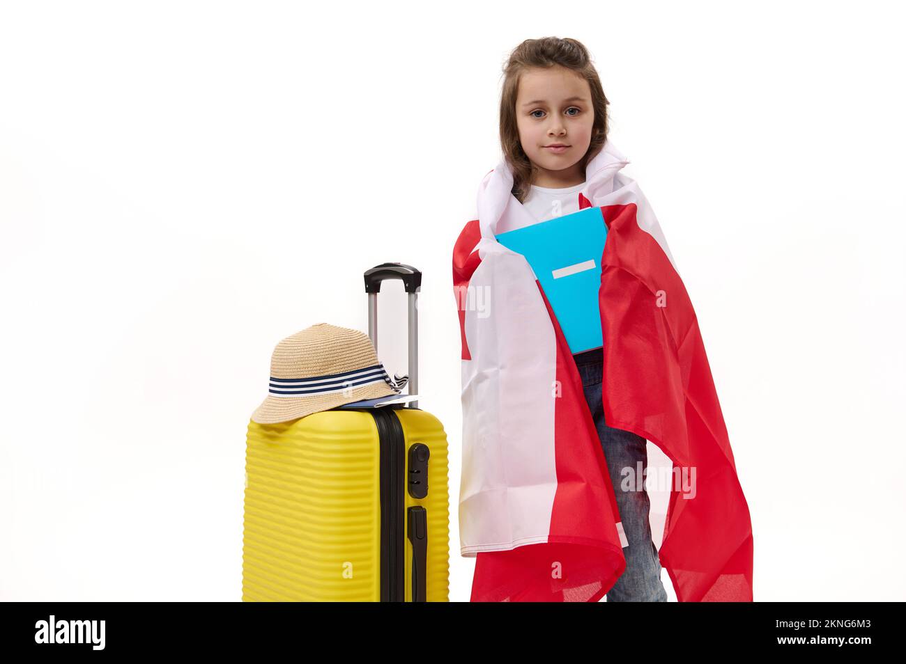 Happy first grader, little girl wrapping in Canada flag, holding a ...