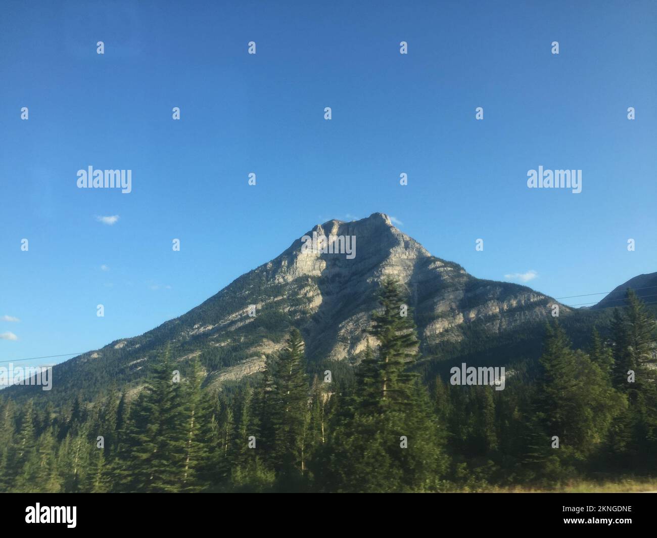 A scenic view of a mountain peak found outdoors on a bright sunny day ...