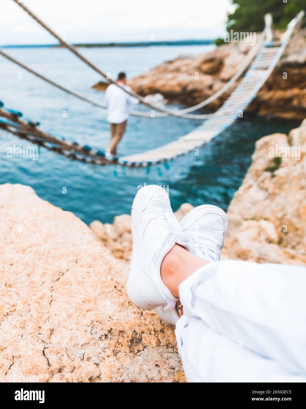 crop picture woman legs at cliff suspension bridge on background Stock ...