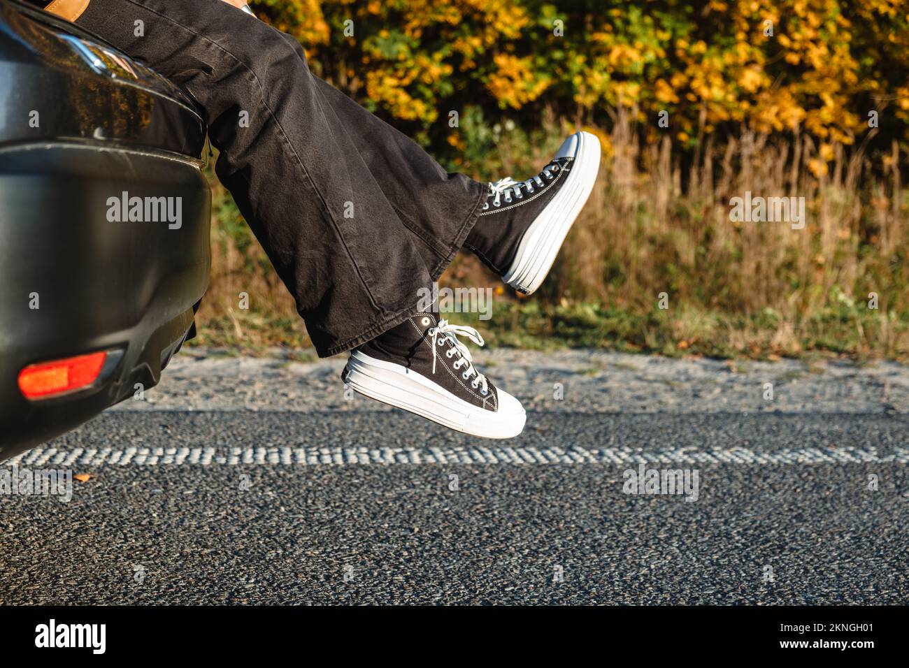 The trunk of a car is full of women whose legs are sticking out. Taking ...