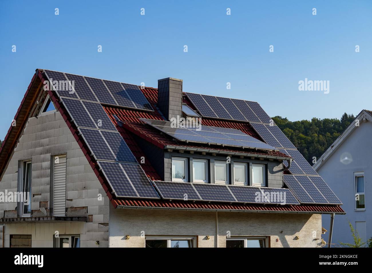 A bunch of solar panels on roofs of a residential neighborhood ...