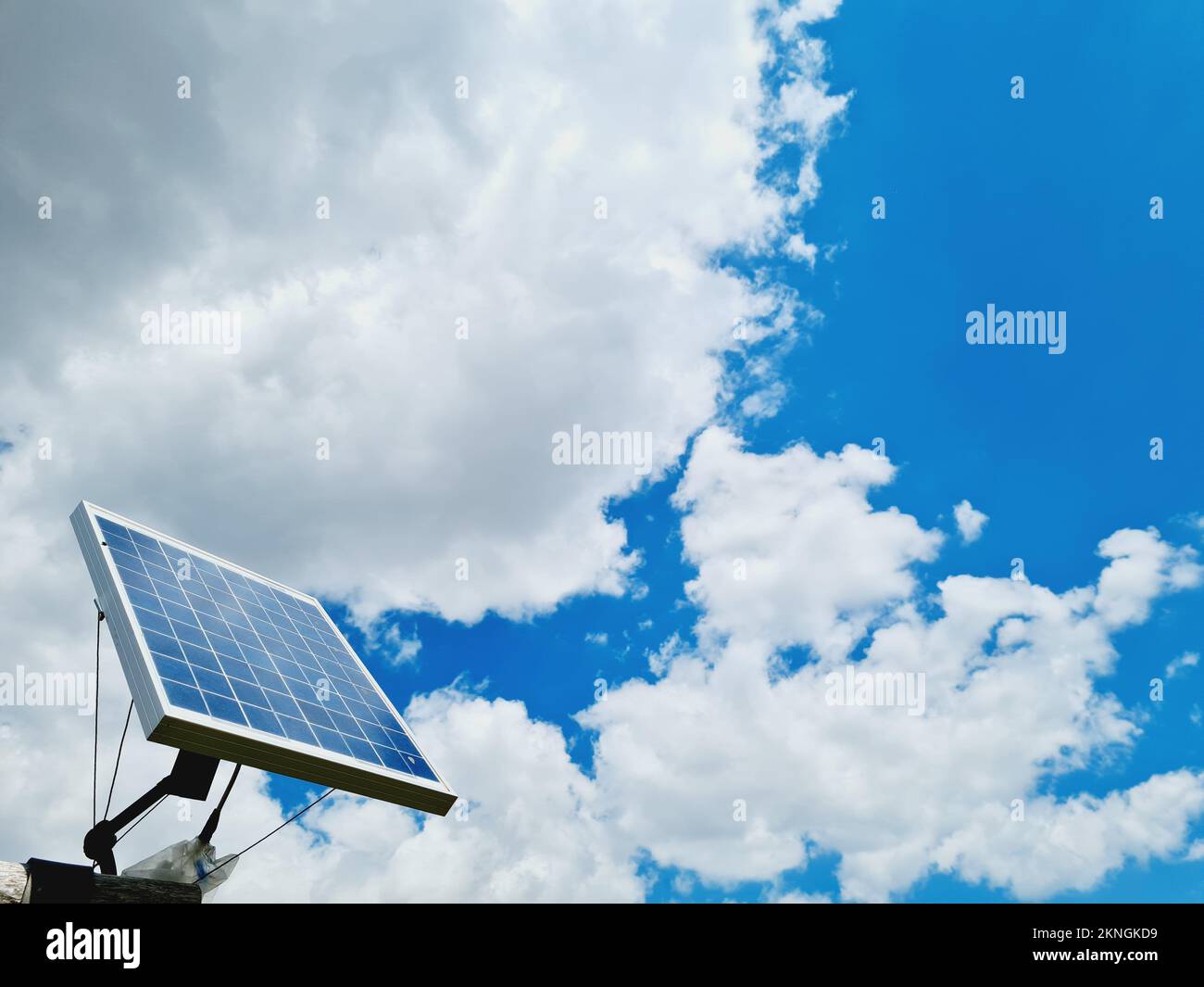 A solar panel facing the cloudy blue sky - sustainable climate visuals ...