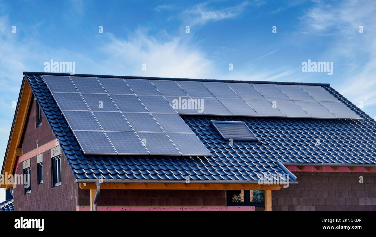 A bunch of solar panels on roofs of a residential neighborhood ...