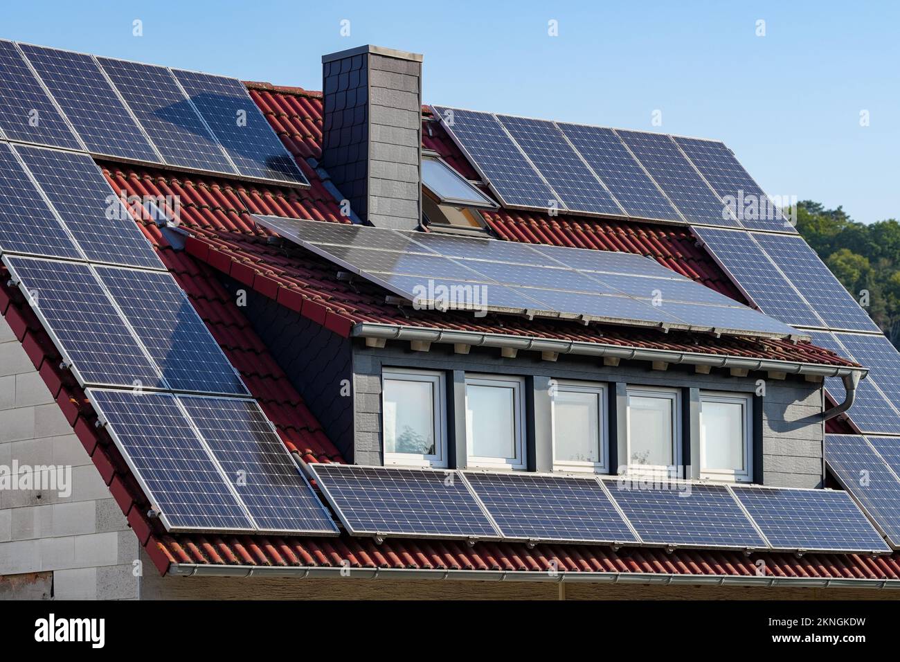 A bunch of solar panels on roofs of a residential neighborhood ...