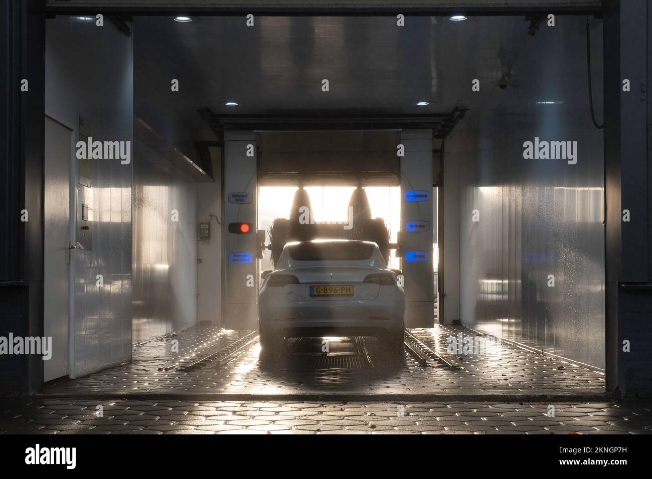 Car is washed in a covered automatic car wash with washing program ...