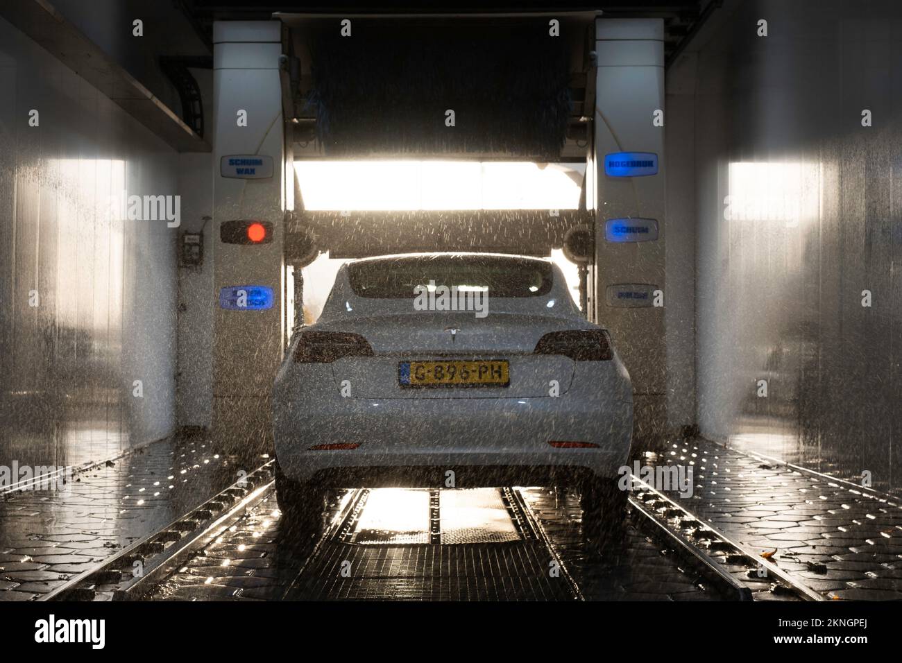 Car is washed in a covered automatic car wash with washing program ...