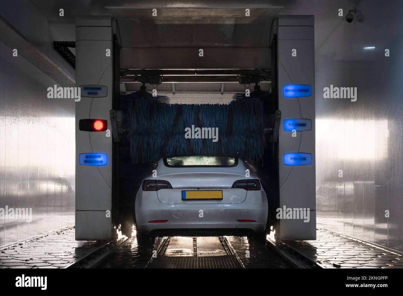 Car is washed in a covered automatic car wash with washing program ...