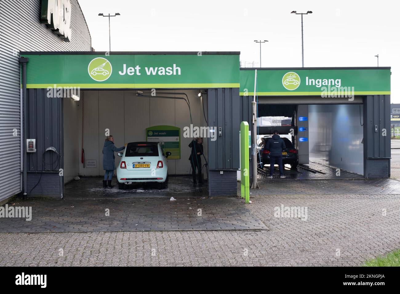 Washing a car. In the cabin on the left this is done manually (jet wash ...