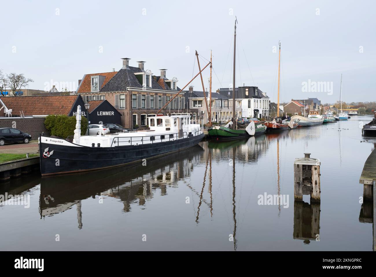 The 'Polderdijk' street with houses and a hotel along the river Rien ...
