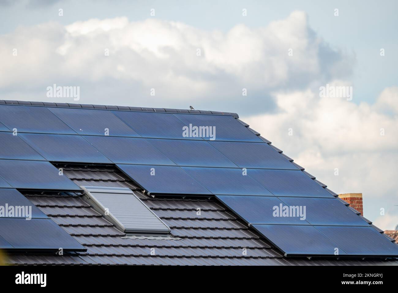 A scenic view of a modern home roof covered with multiple solar panels ...